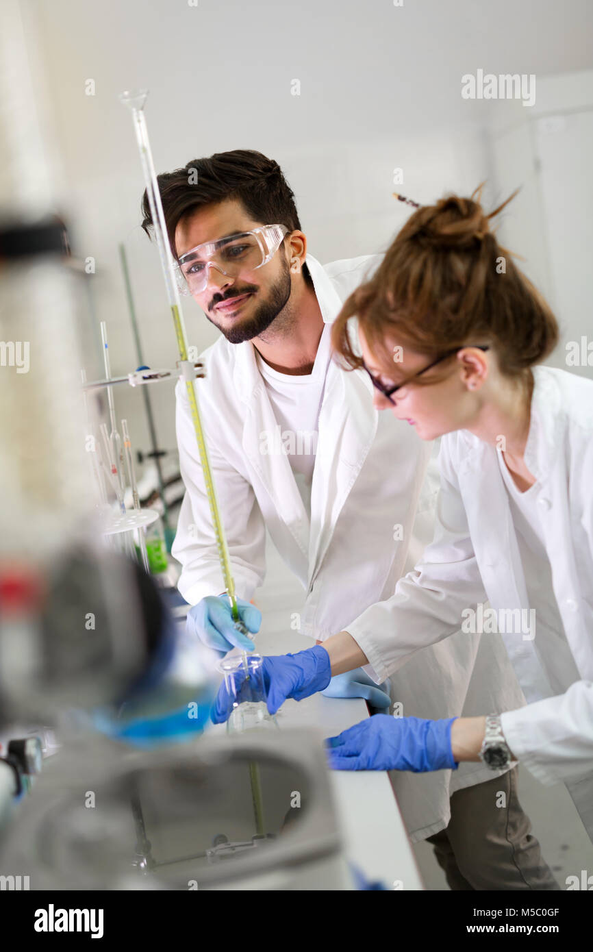 Group of scientists working at laboratory Stock Photo - Alamy