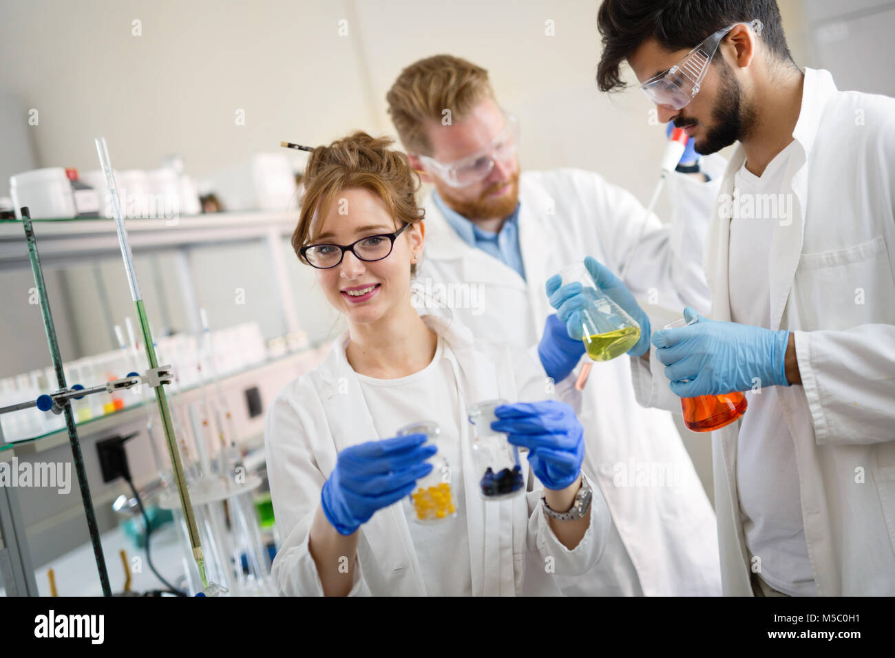 Young students of chemistry working in laboratory Stock Photo - Alamy