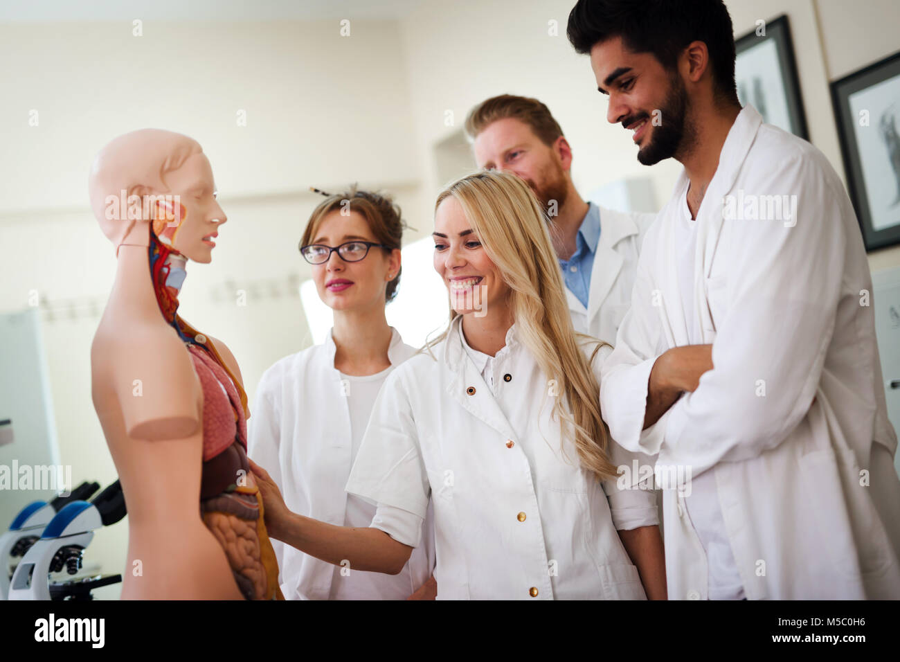 Students of medicine examining anatomical model in classroom Stock ...