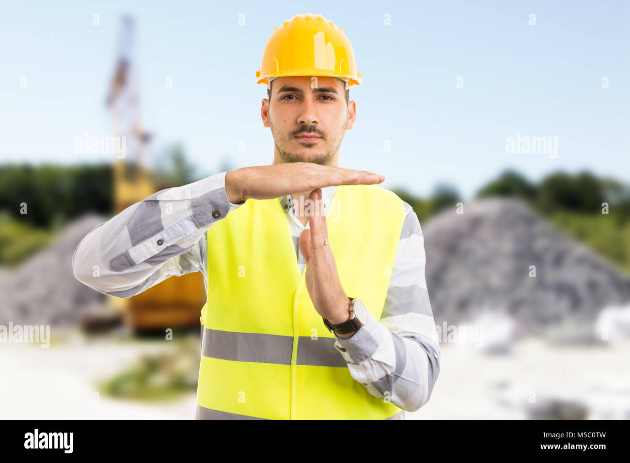 Architect or engineer making time out pause break gesture on ...