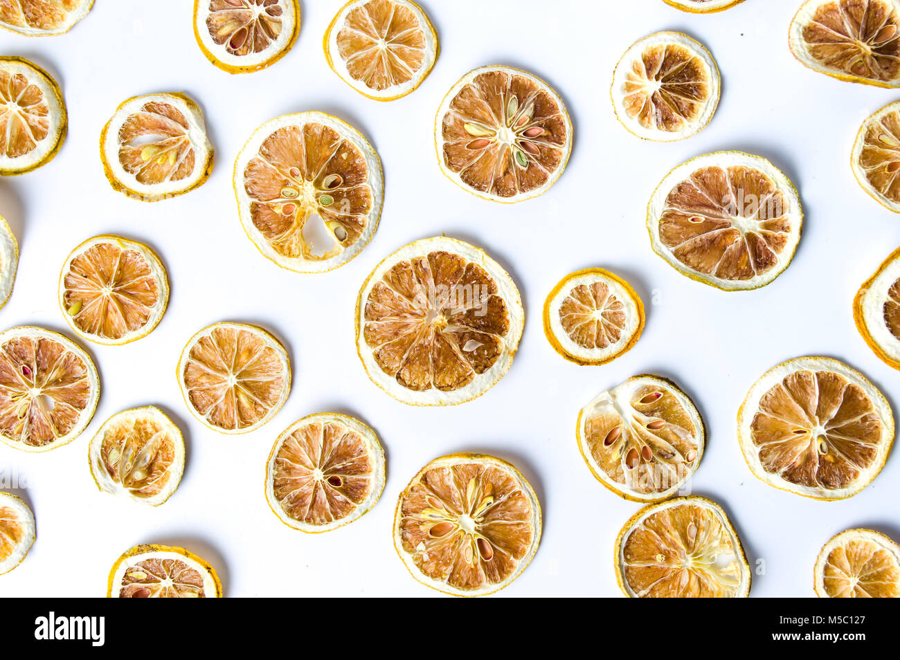 Dried sliced lemon background pattern isolated on white Stock Photo - Alamy