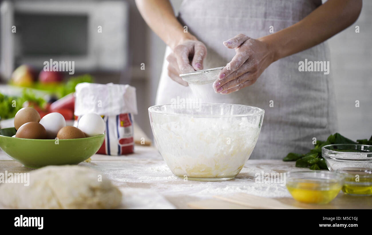 Baker throwing flour over table hi-res stock photography and images - Alamy