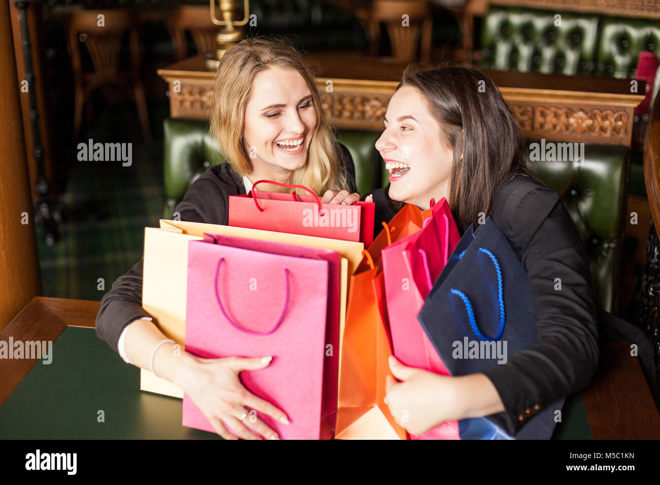 Beautiful girls having fun when shopping in a store Stock Photo - Alamy
