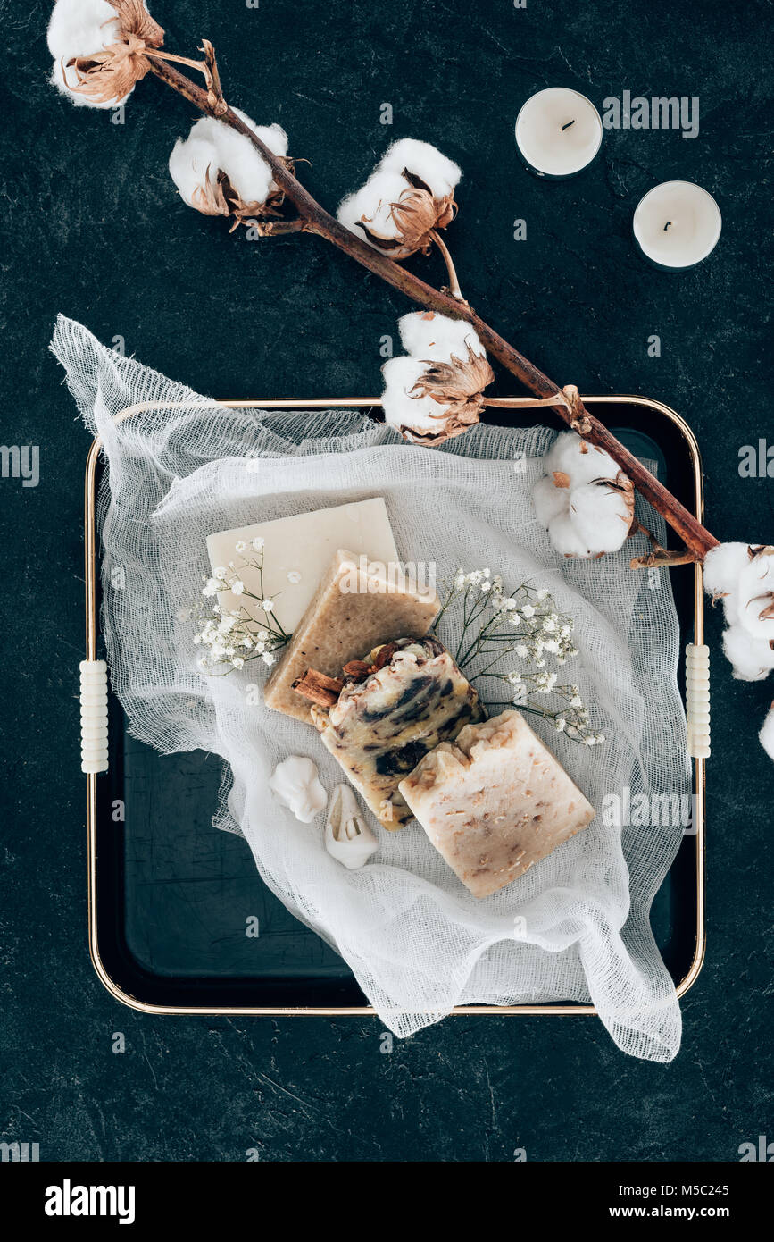 flat lay with natural homemade soap and dried cotton flowers on gauze ...