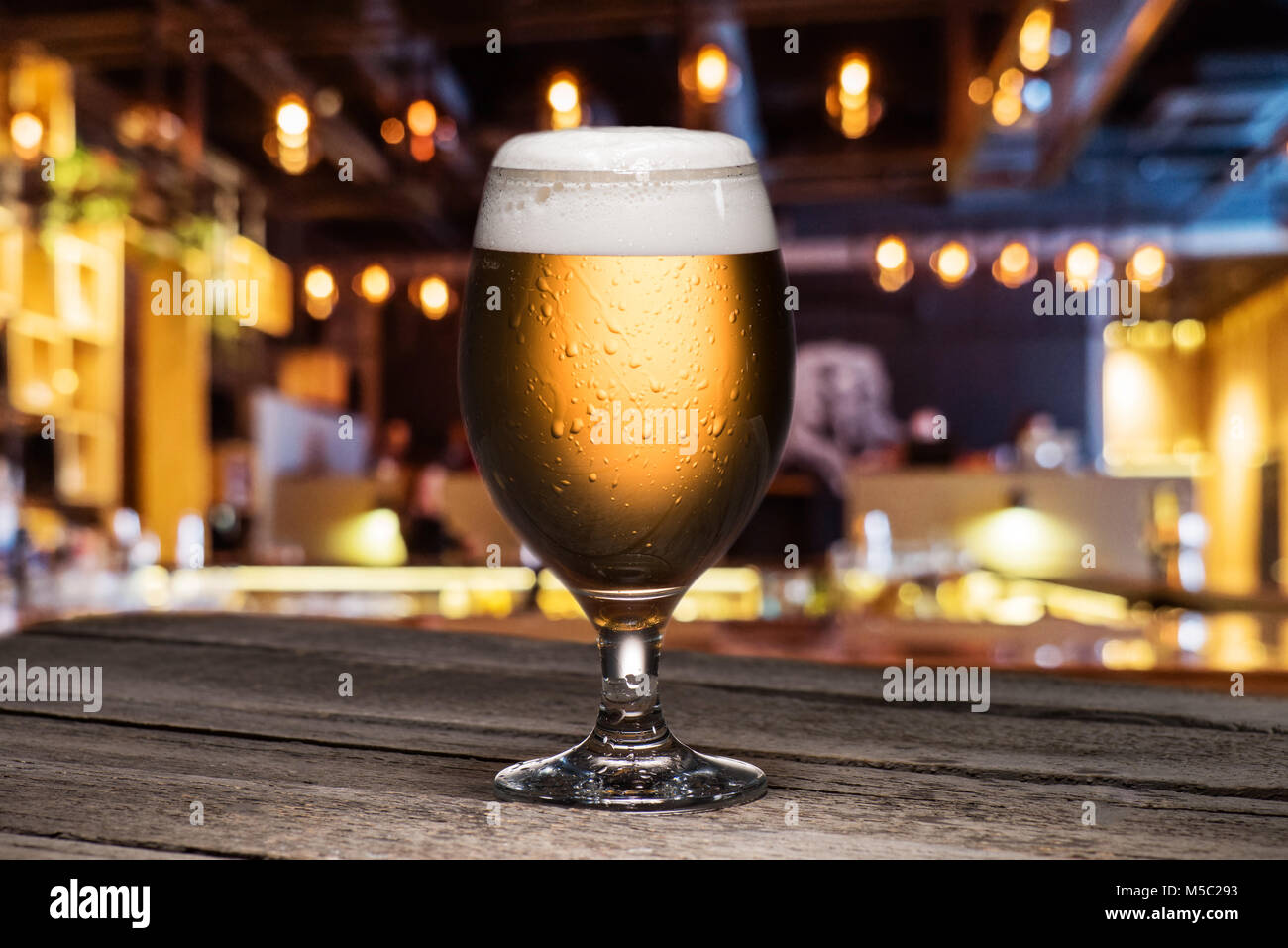 glass of beer on table Stock Photo - Alamy