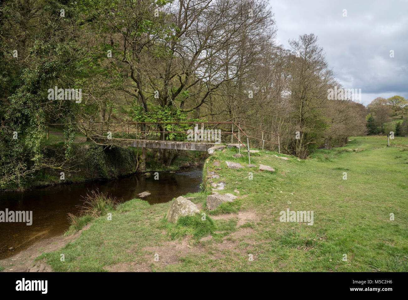 Footpath and bridge beside the river Goyt near Taxal in the Goyt Valley ...