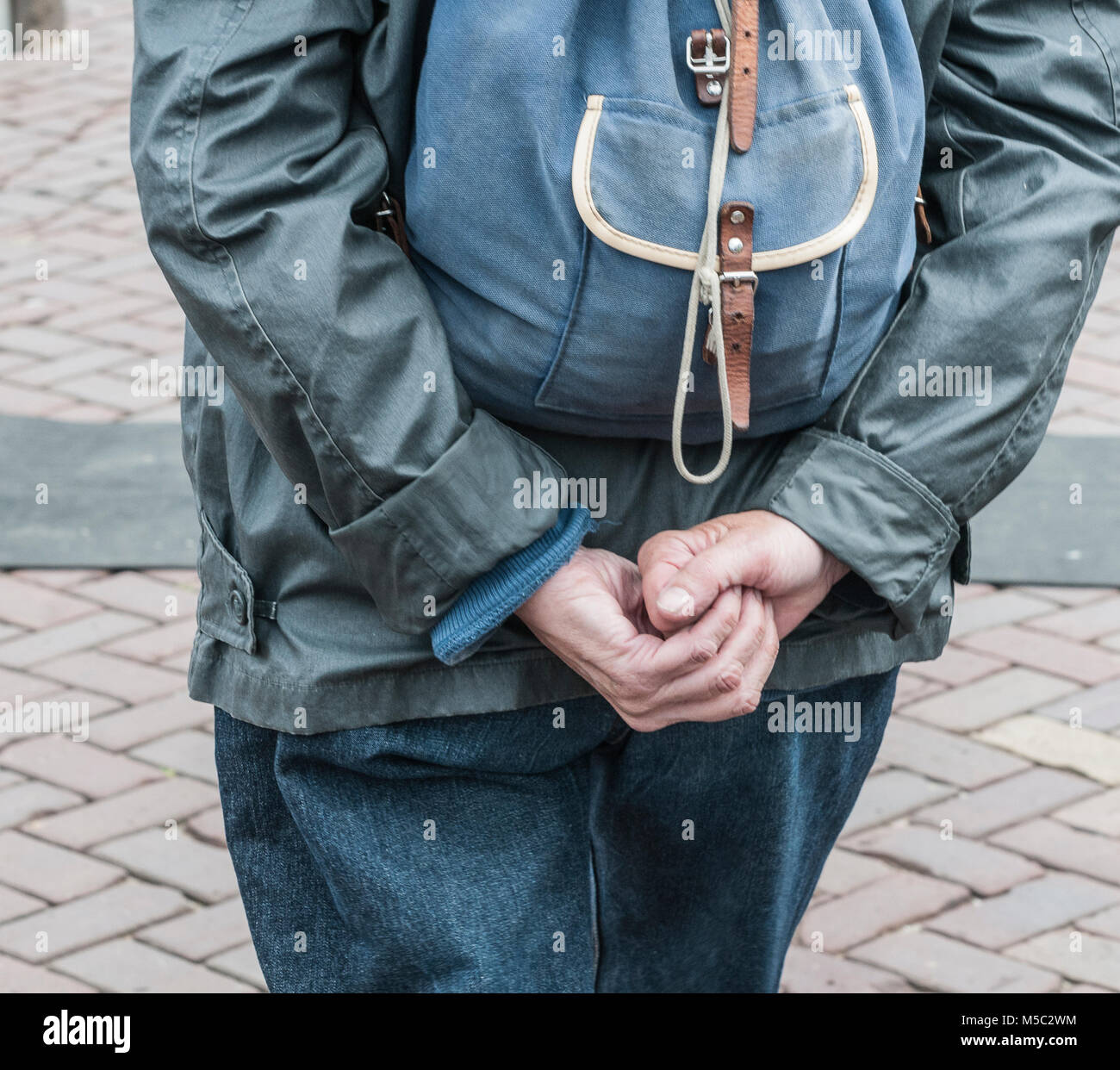 a male person with his hands on the back Stock Photo - Alamy