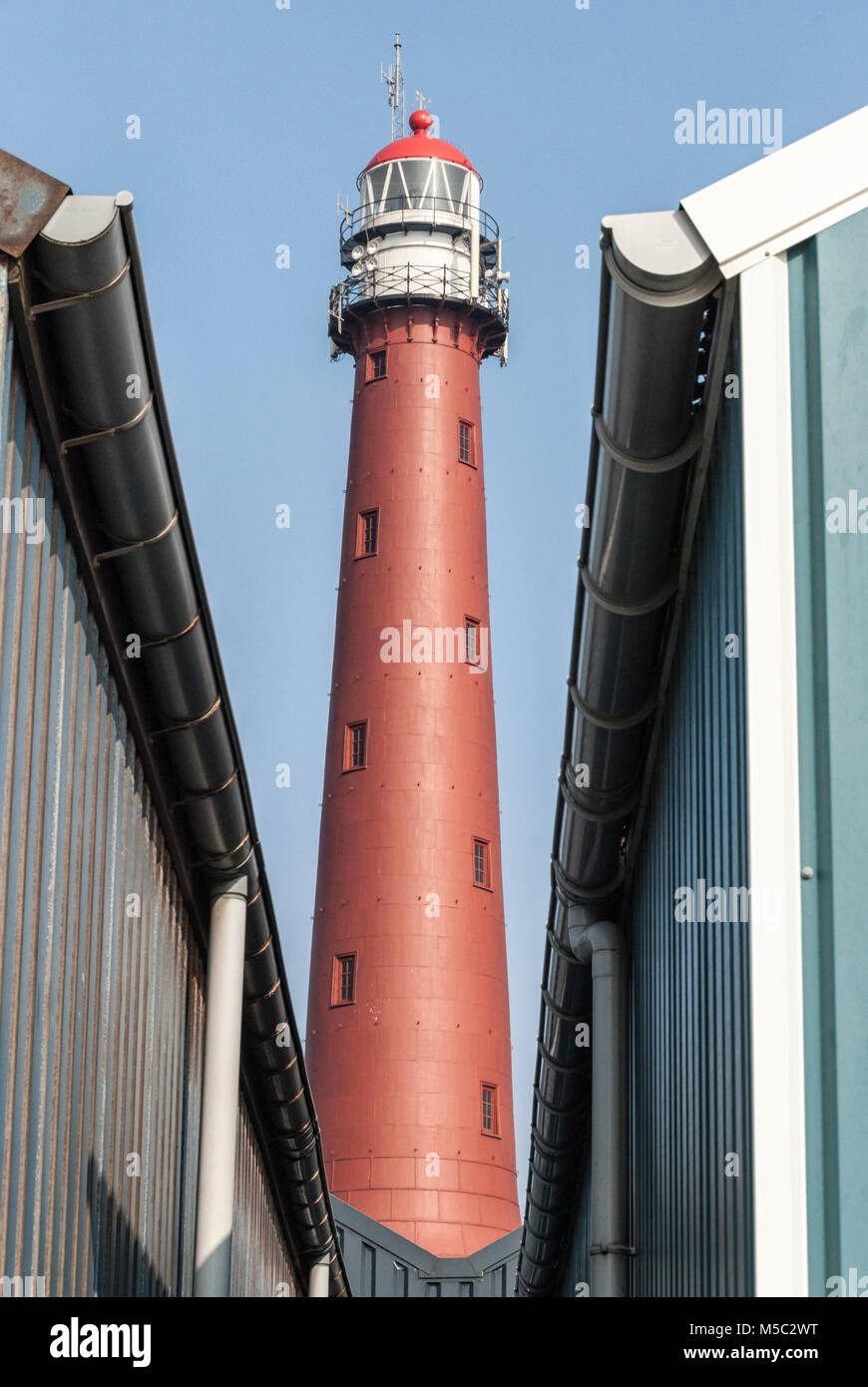 lighthouse situated between two buildings Stock Photo - Alamy
