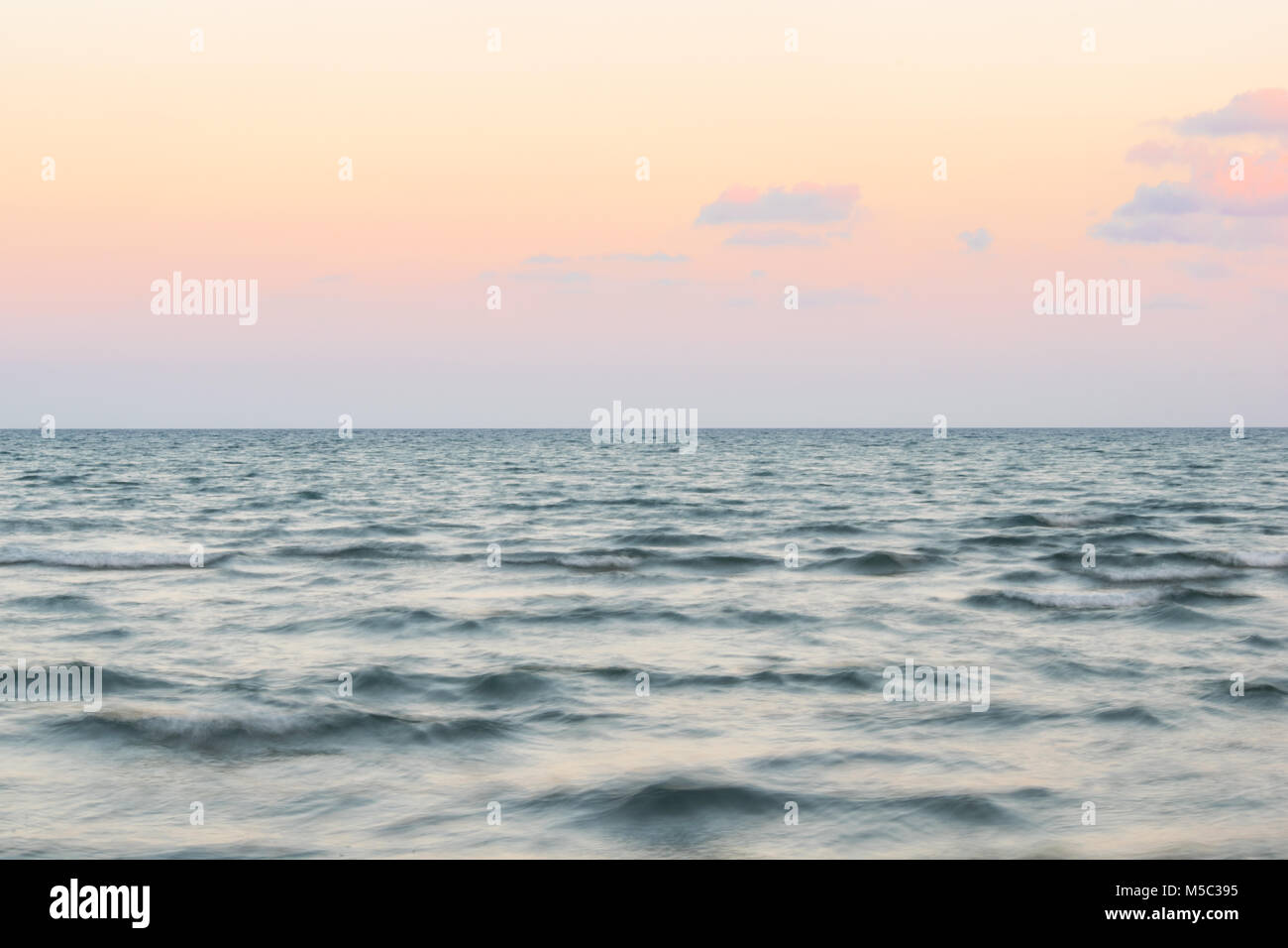 sea waves and horizon with read sky Stock Photo - Alamy