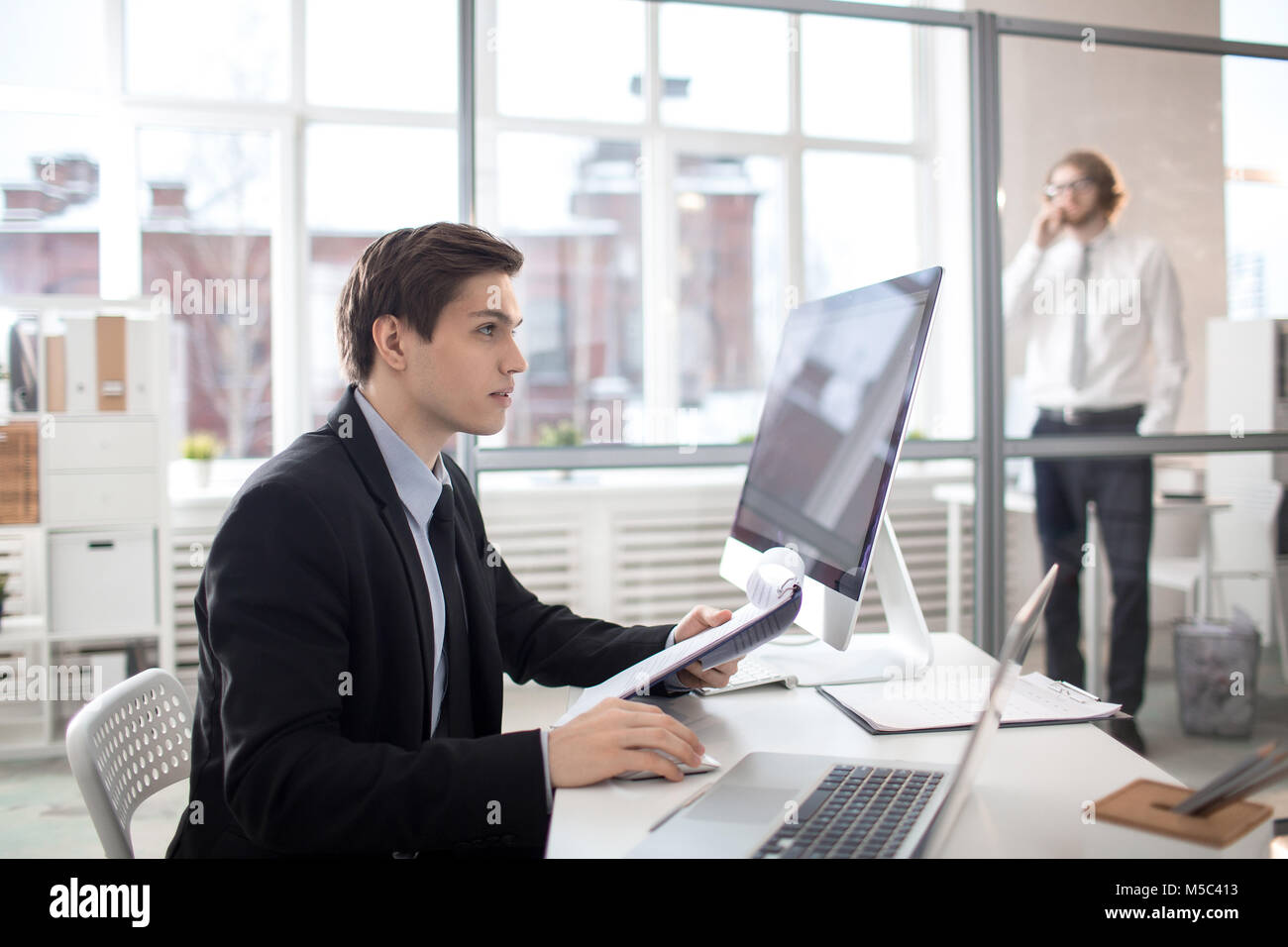 Checking banker hi-res stock photography and images - Alamy