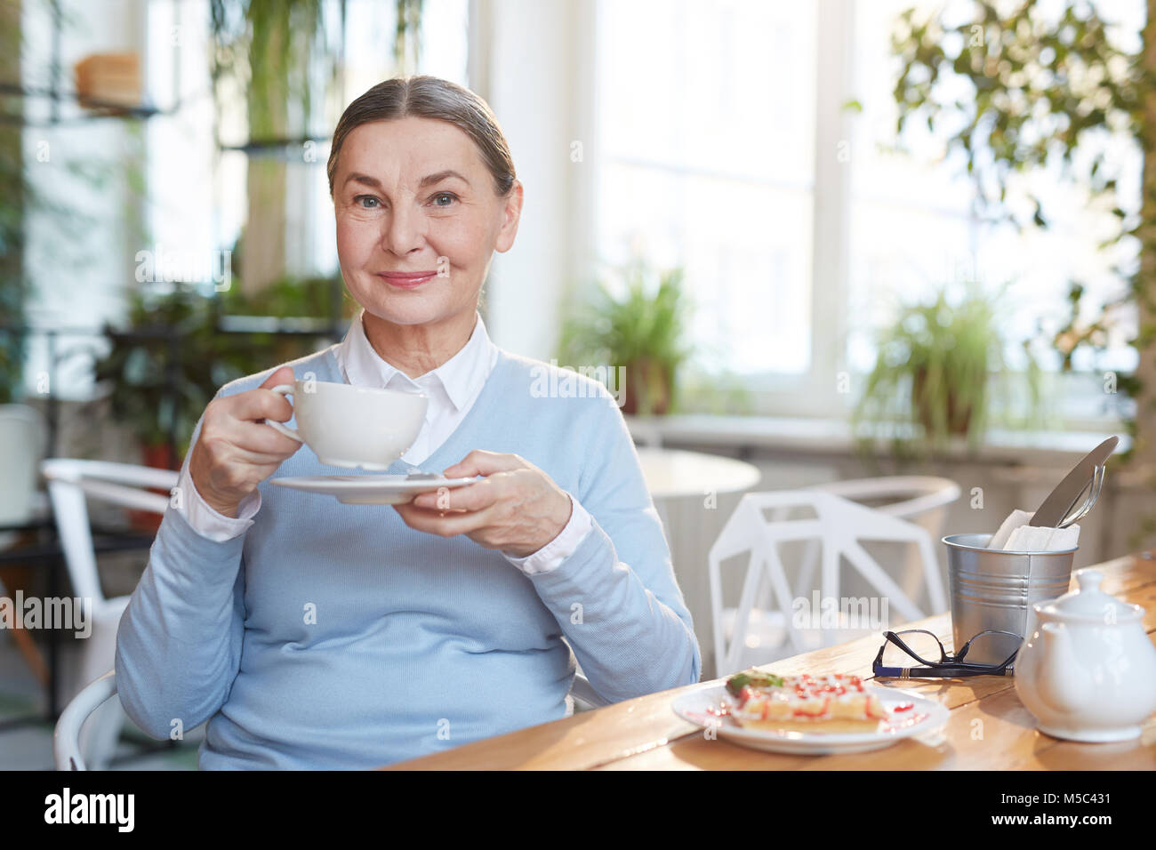 Having tea in cafe Stock Photo - Alamy