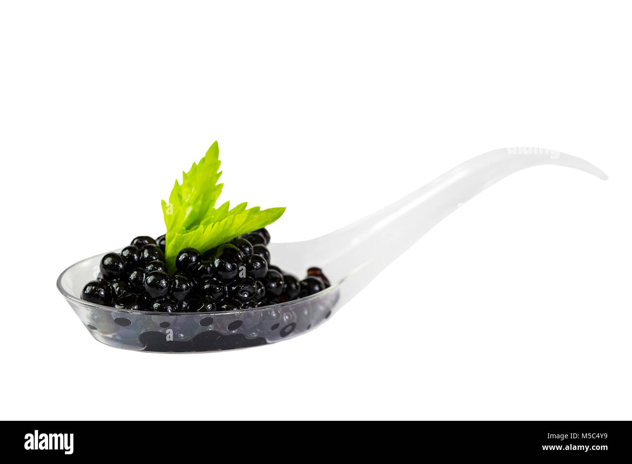 Plastic spoons with fish caviar on a white background Stock Photo - Alamy