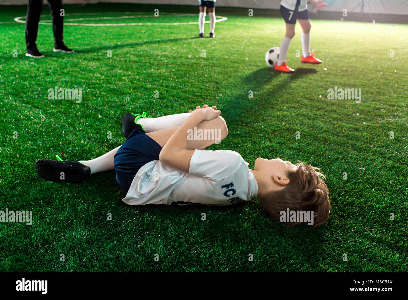 Boy with hurt knee Stock Photo - Alamy