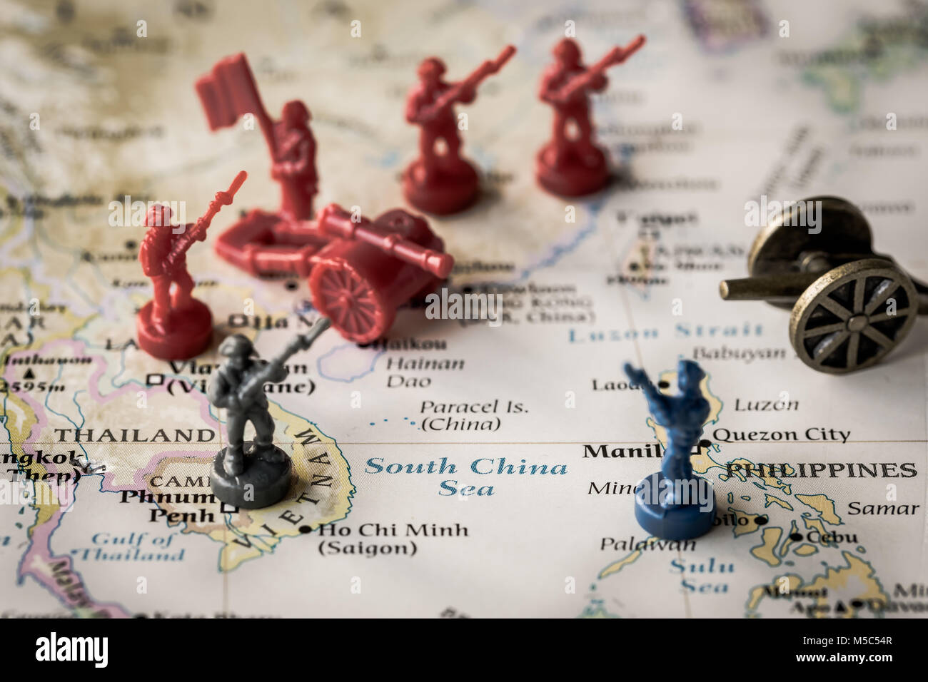 Macro close up of toy soldiers on a map representing conflict and ...