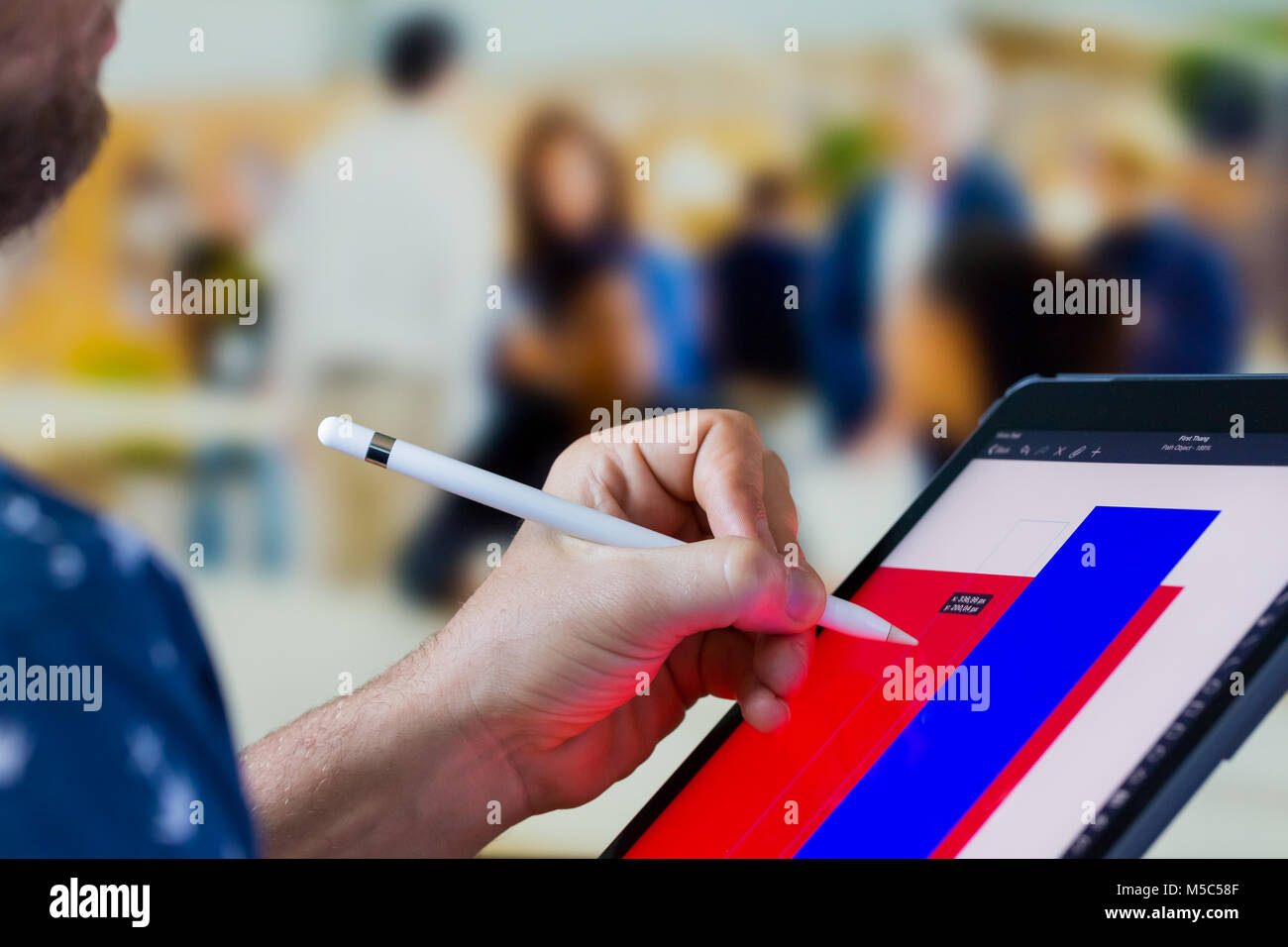 Digital Artist Graphic Designer using a digital pen on a mobile tablet ...