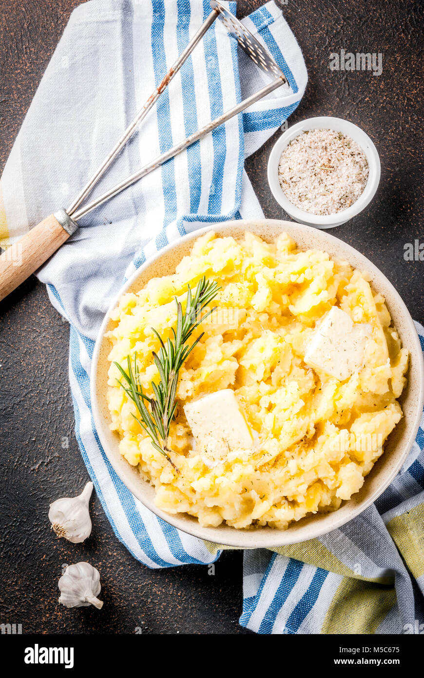 Homemade Garlic Herb Mashed Potatoes, boiled puree, on dark rusty table ...