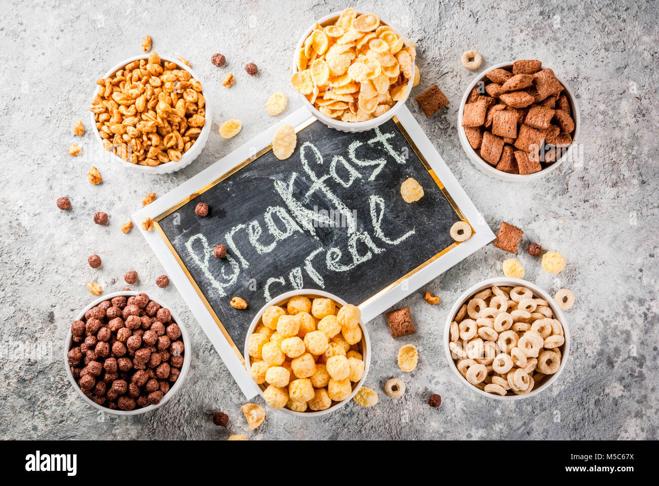 Set of various breakfast cereal corn flakes, puffs, pops, grey stone ...
