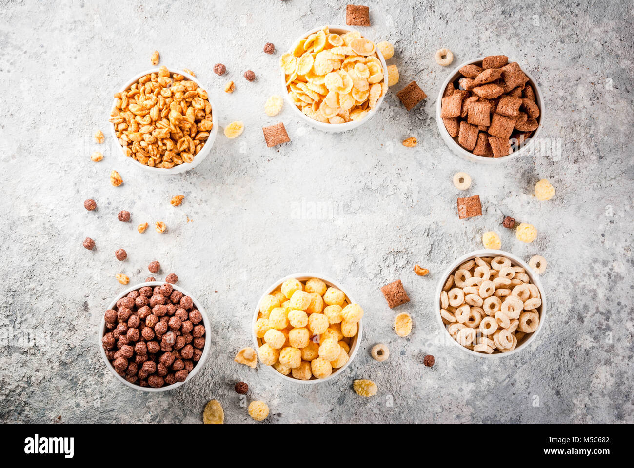 Set of various breakfast cereal corn flakes, puffs, pops, grey stone ...