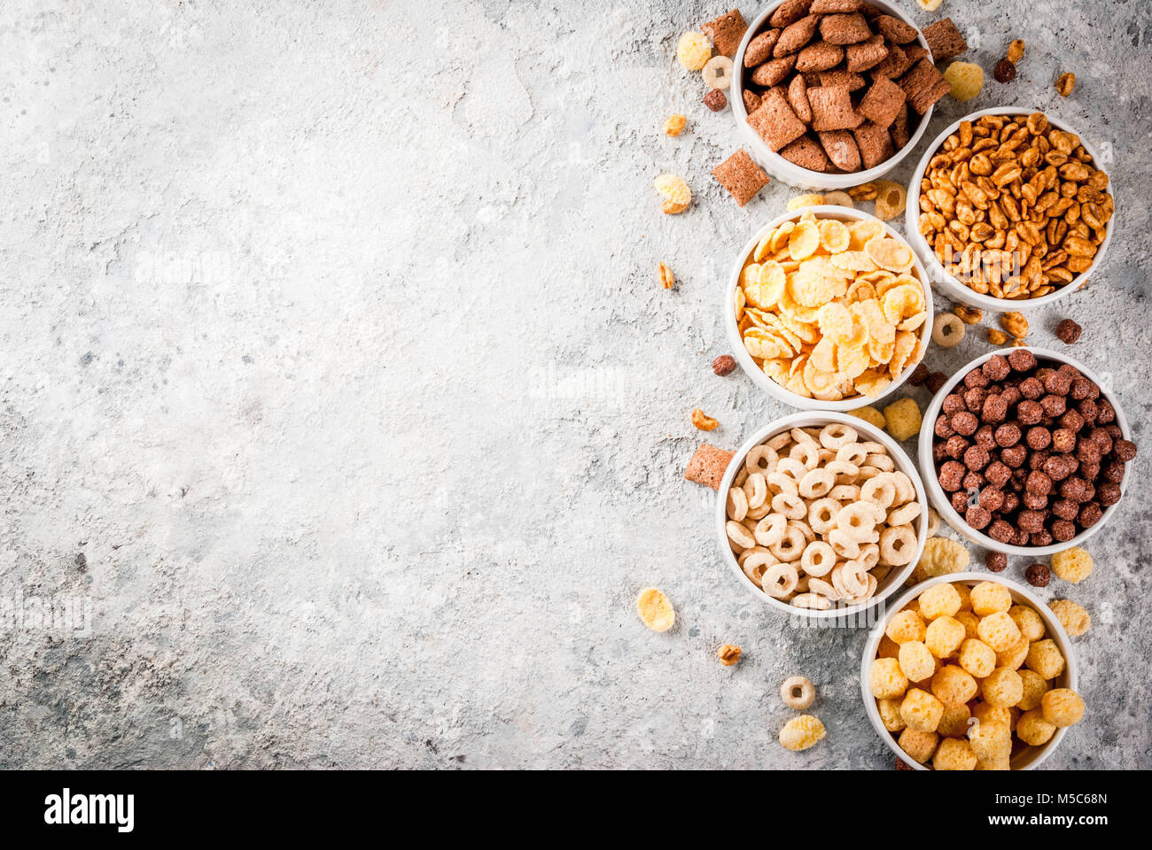 Set of various breakfast cereal corn flakes, puffs, pops, grey stone ...