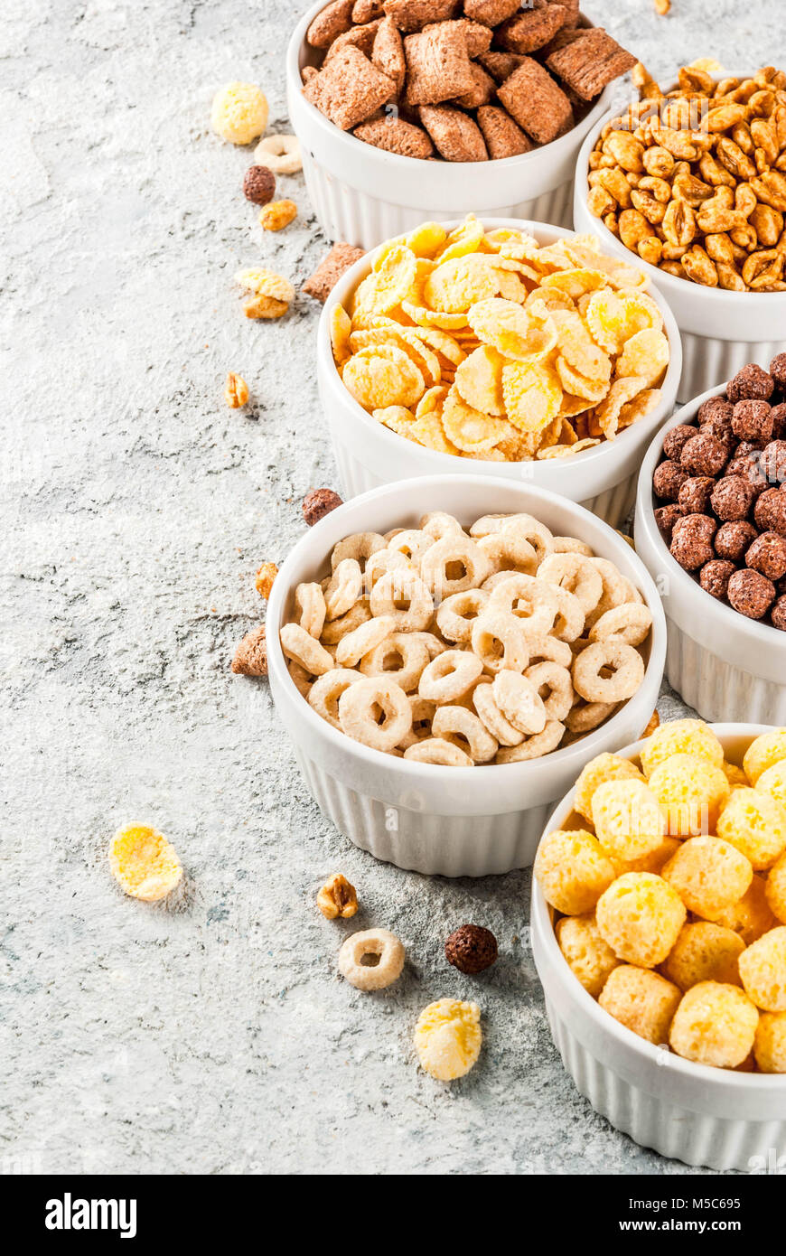 Set of various breakfast cereal corn flakes, puffs, pops, grey stone ...