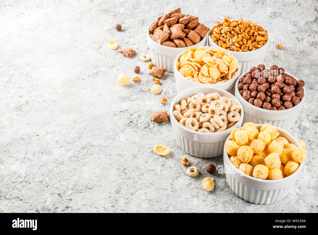Set of various breakfast cereal corn flakes, puffs, pops, grey stone ...