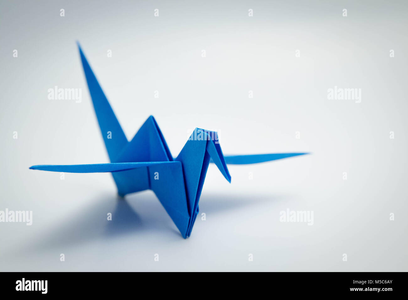 Single blue bird origami isolated on white close Stock Photo - Alamy