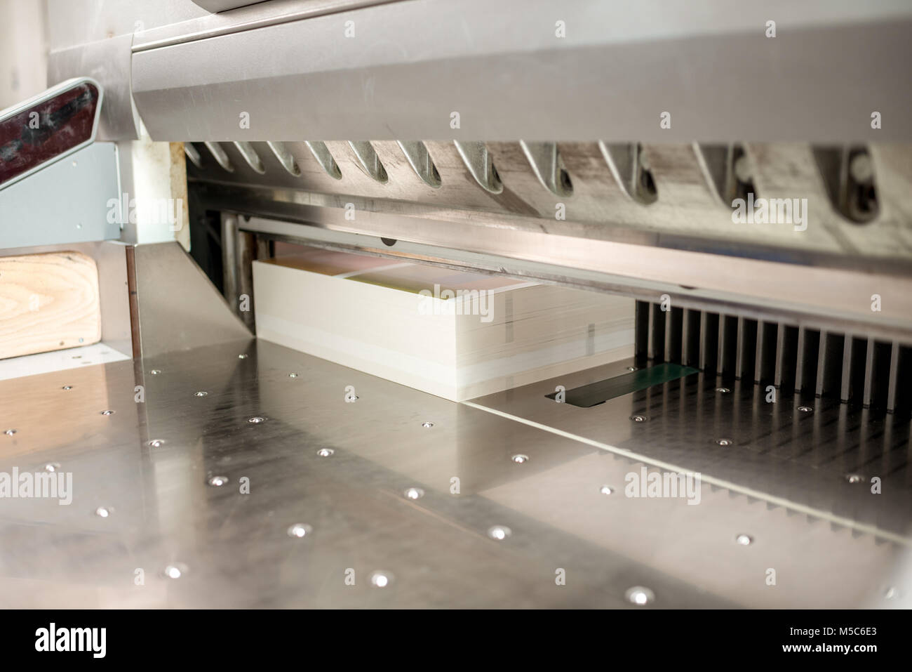 Cutting paper with professional press machine Stock Photo - Alamy