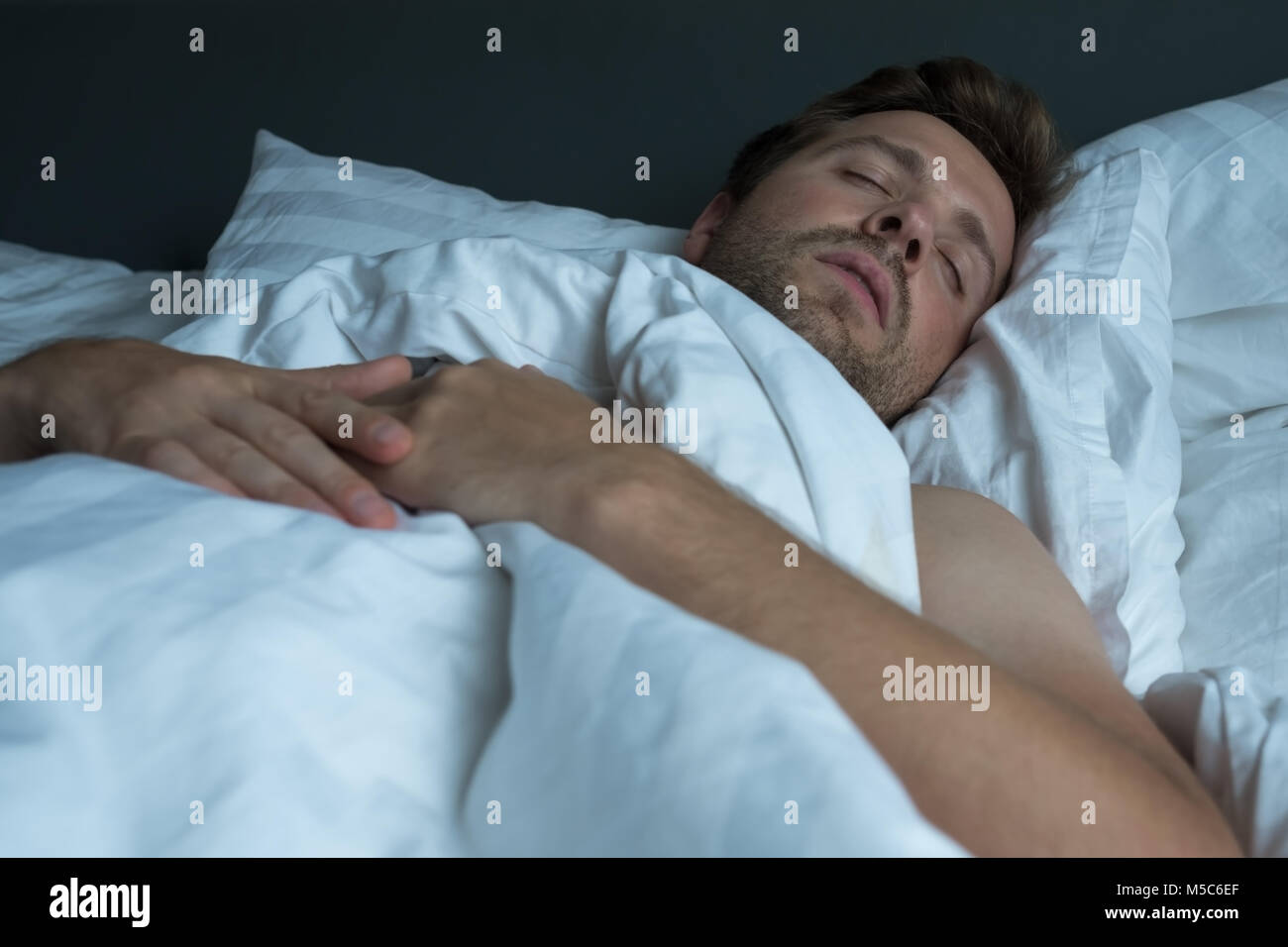 caucasian man napping with happy face expression Stock Photo - Alamy