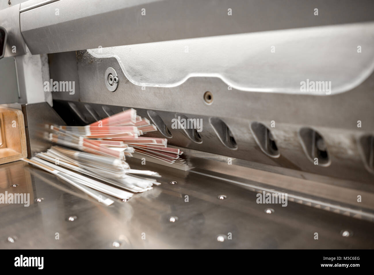 Cutting paper with professional press machine Stock Photo - Alamy