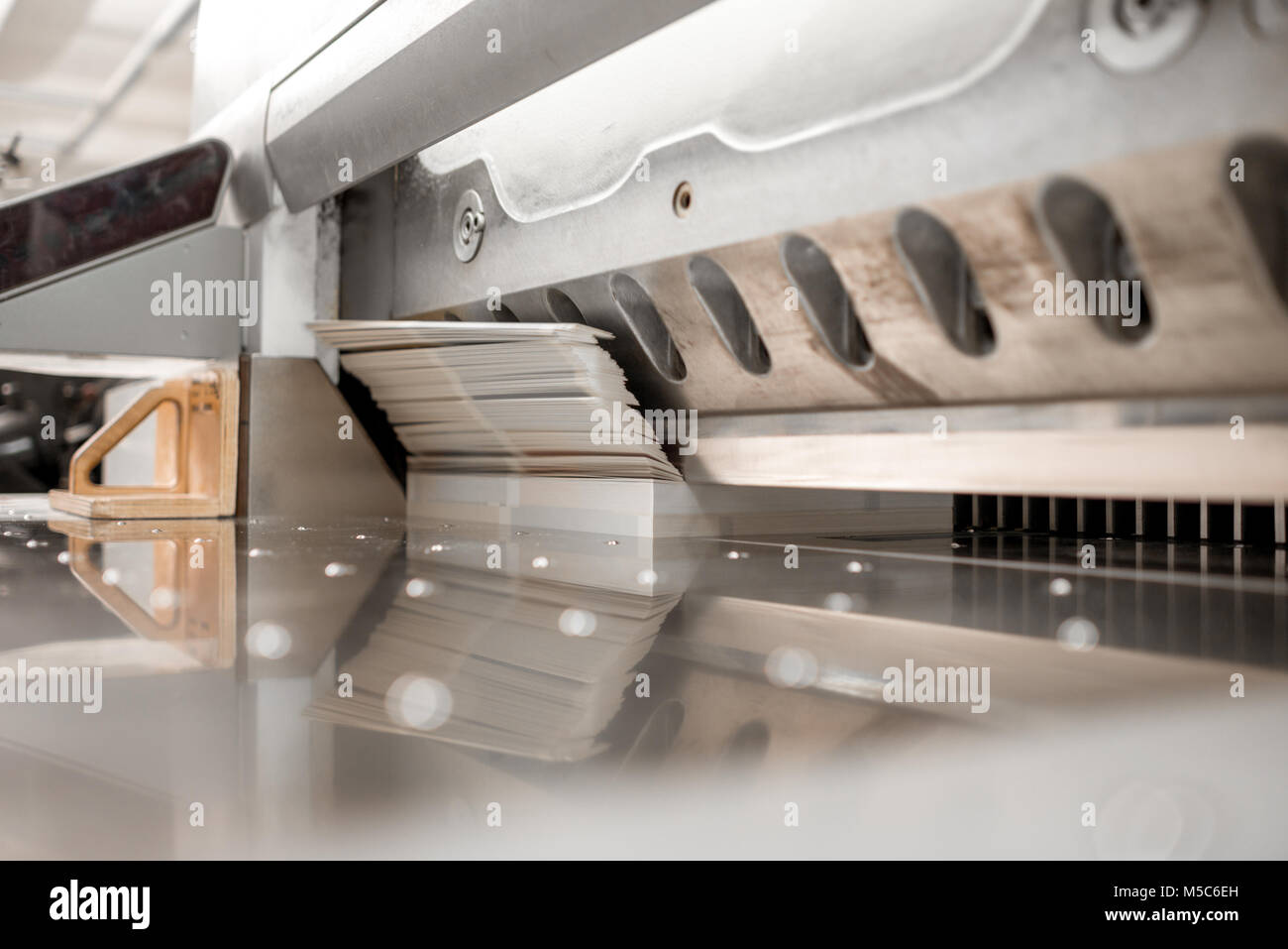 Cutting paper with professional press machine Stock Photo - Alamy
