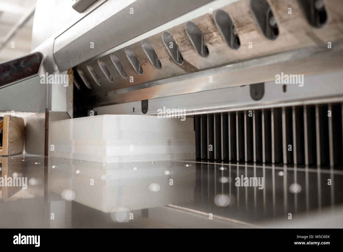 Cutting paper with professional press machine Stock Photo - Alamy