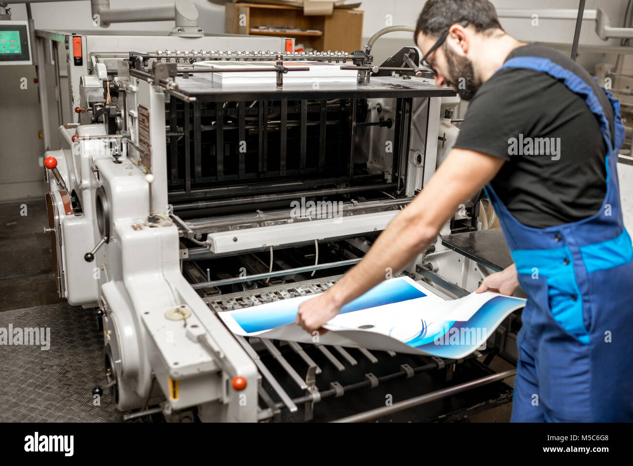 Checking printing quality at the printing plant Stock Photo - Alamy