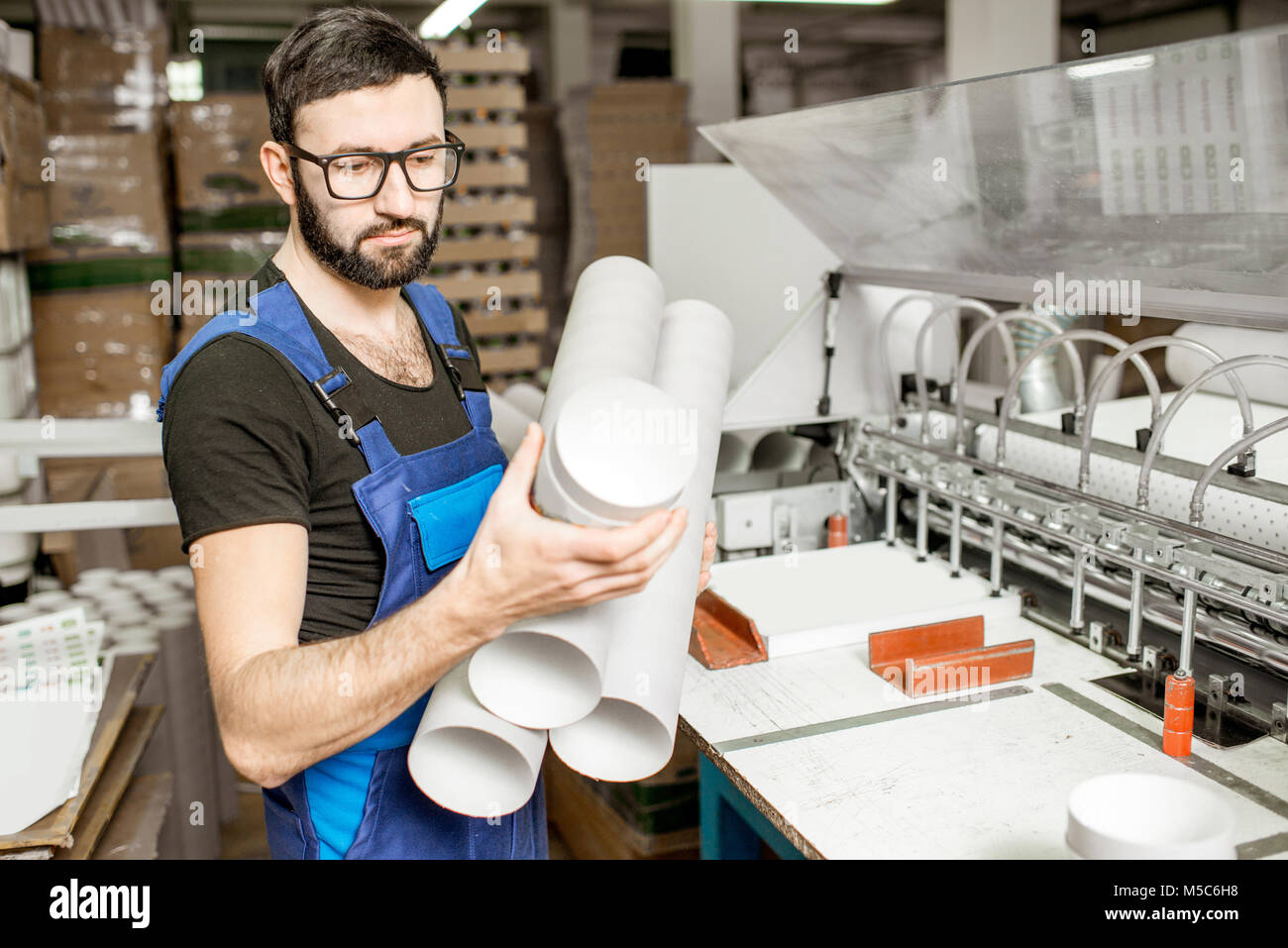 Worker portrait with paper tubes Stock Photo - Alamy