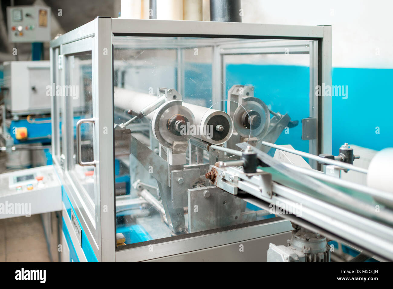 Machine making paper tube packaging Stock Photo - Alamy