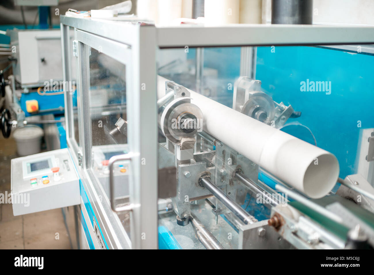Machine making paper tube packaging Stock Photo - Alamy