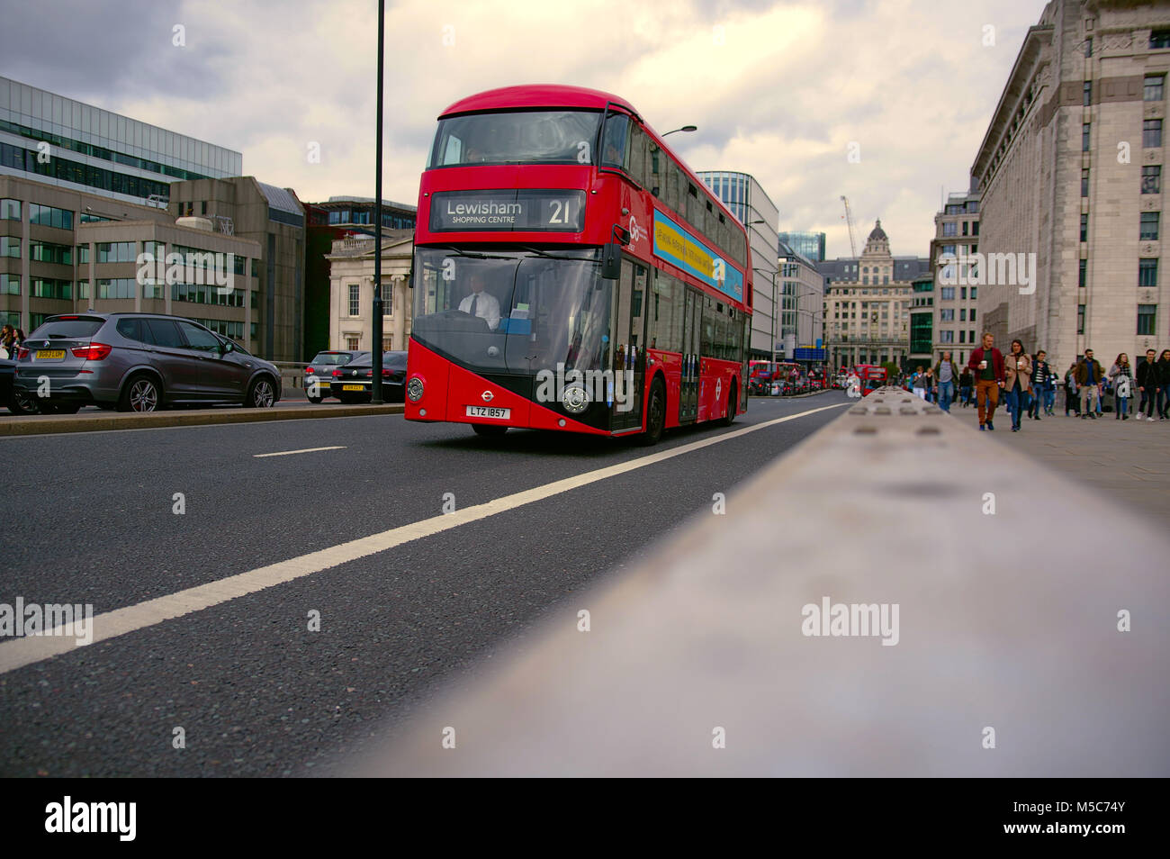 A typical London road with cars, buses and pedestrians between ...