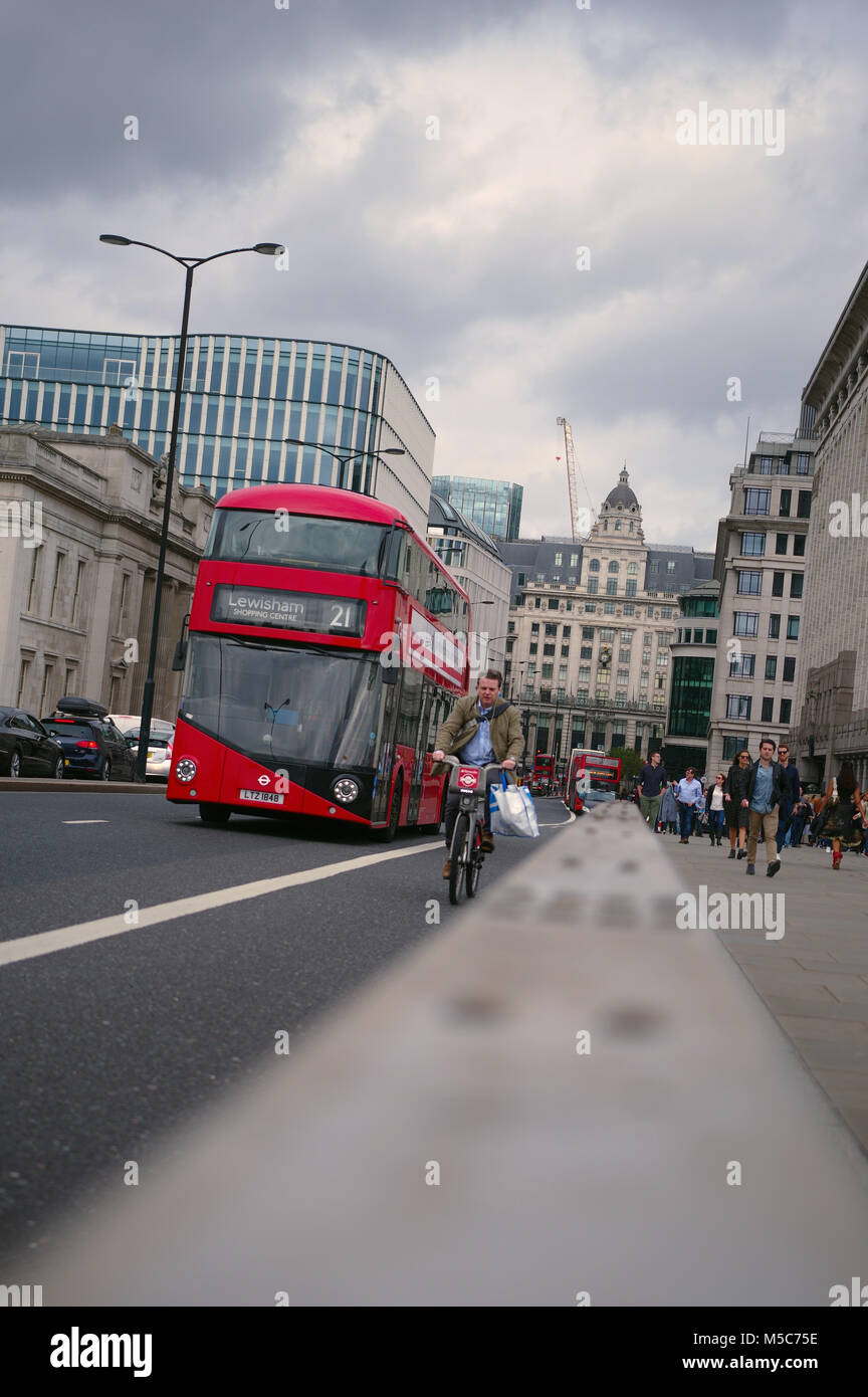 A typical London road with cars, buses and pedestrians between ...