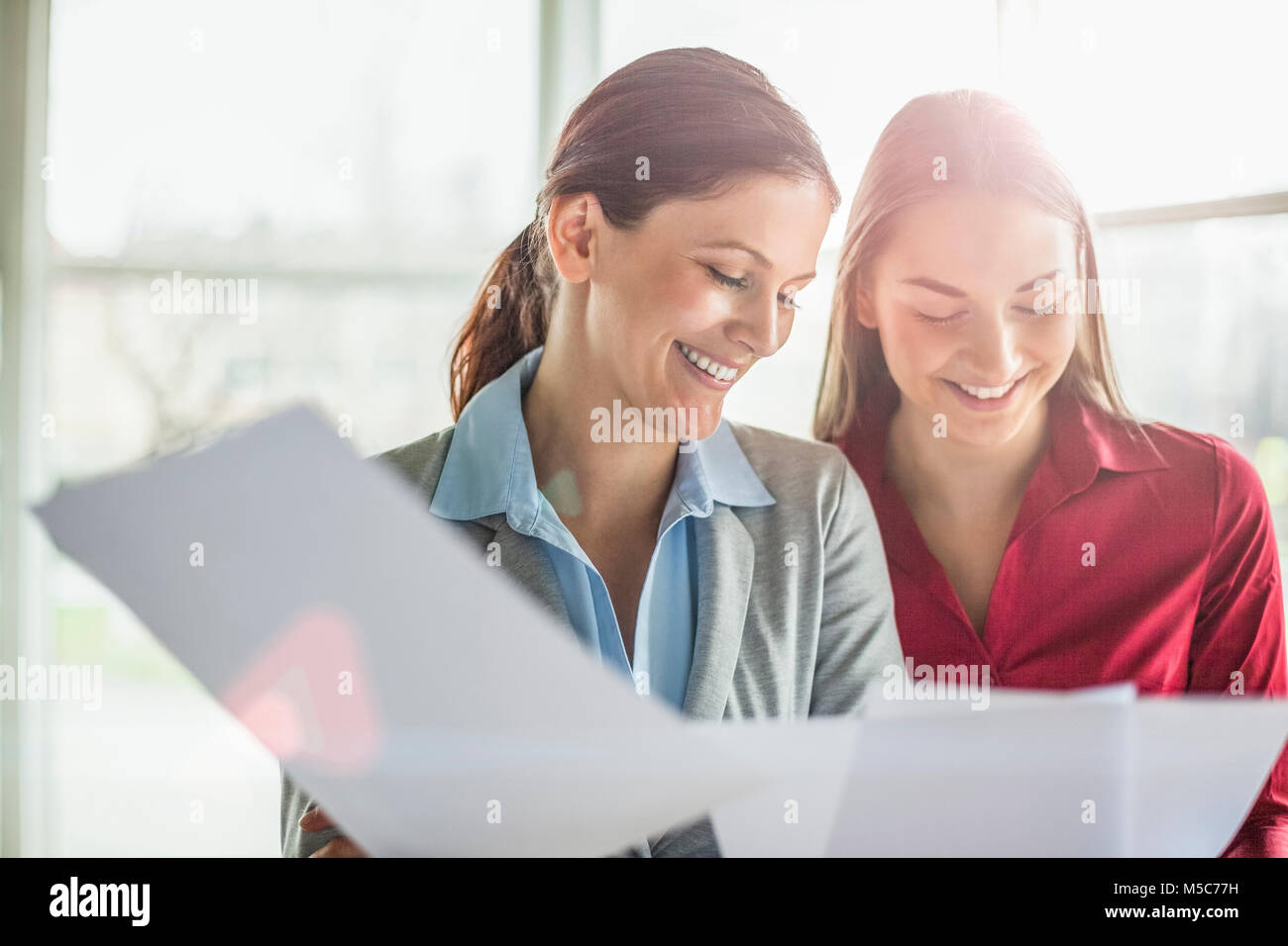 Two women reviewing documents hi-res stock photography and images - Alamy