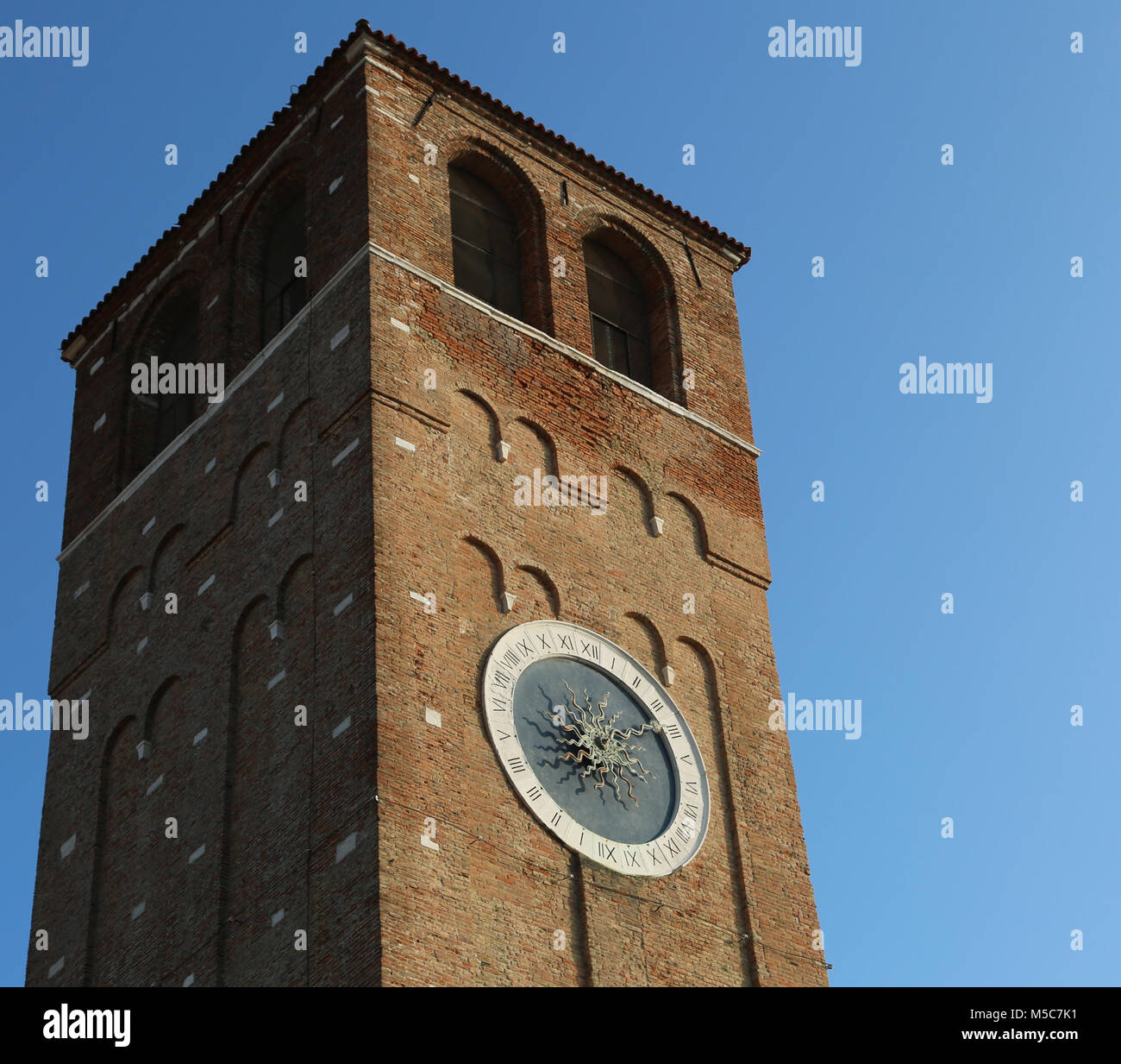 high clock tower in downtown of Chioggia Island near Venice in Italy ...