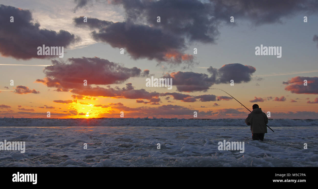 surf fishing scene at sunset Stock Photo - Alamy