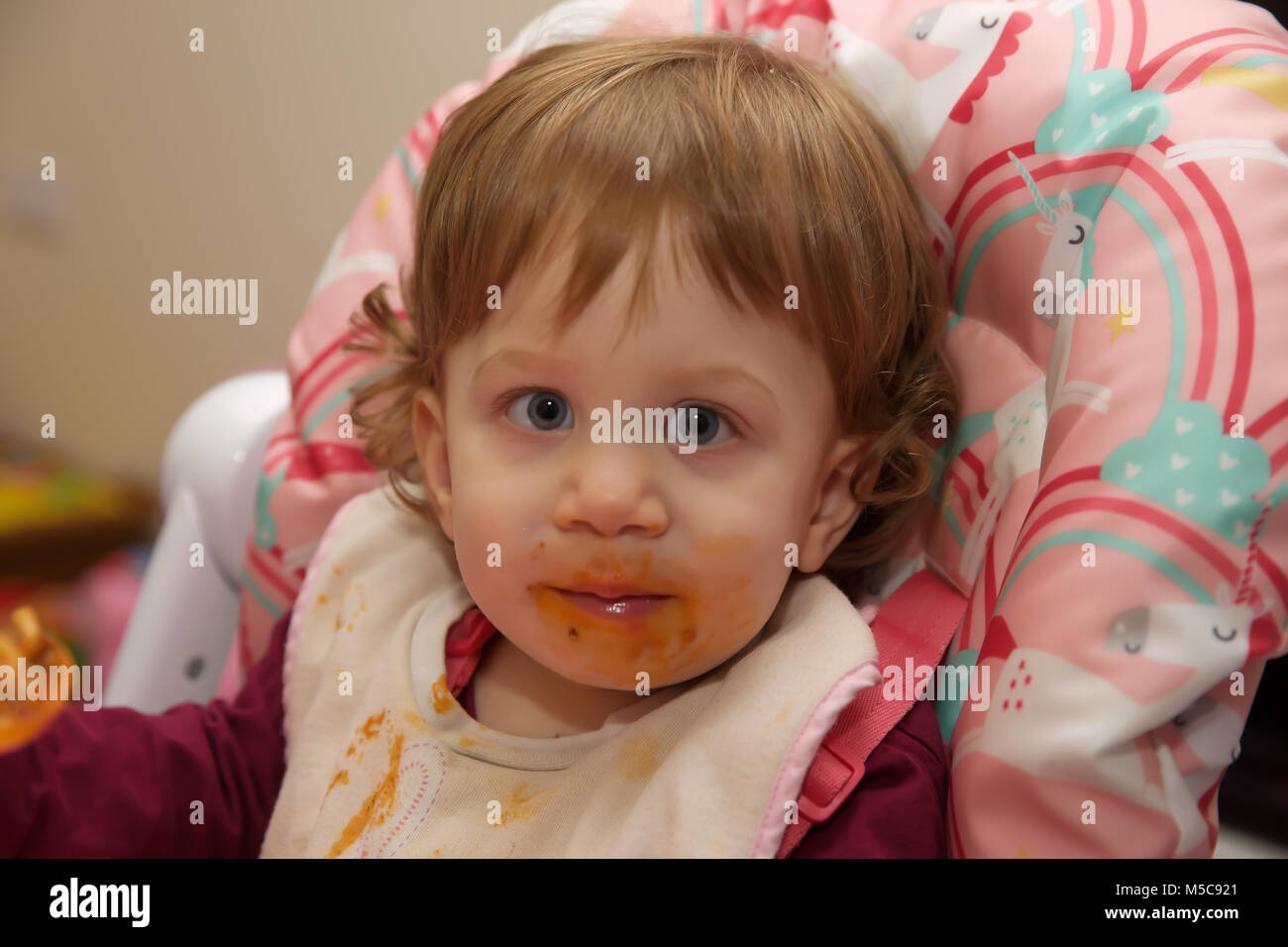 A female toddler with a messy face after eating Spaghetti Bolognaise ...
