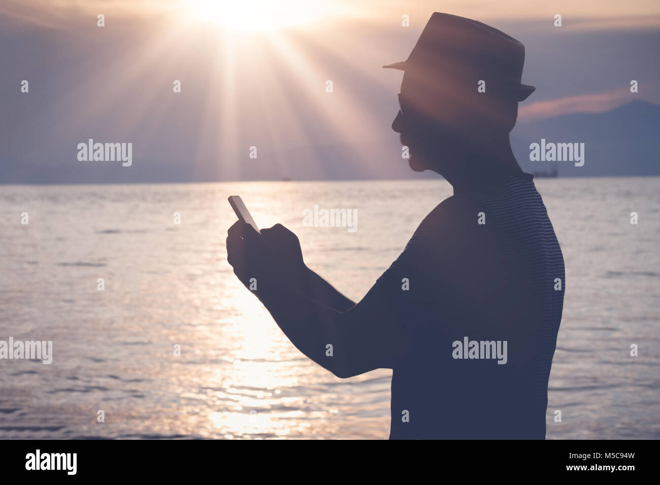 Man looking at phone silhouette hi-res stock photography and images - Alamy