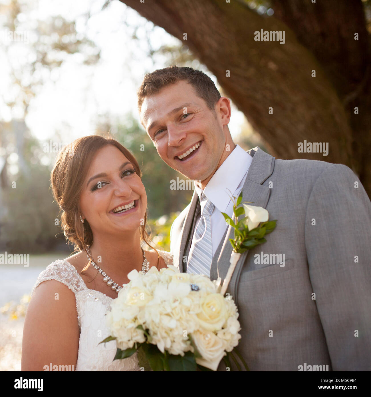 Happy newly married couple outdoors in sunlight Stock Photo - Alamy