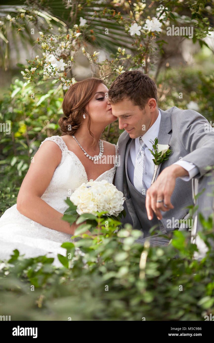 Newly married couple having intimate moment together in garden Stock ...