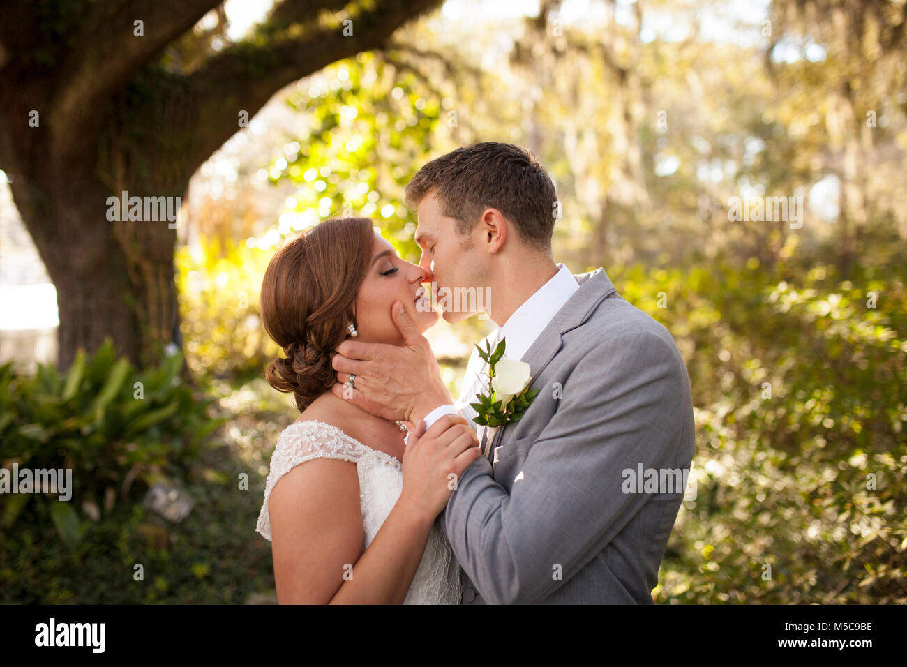 Newly married couple having intimate moment in garden Stock Photo - Alamy
