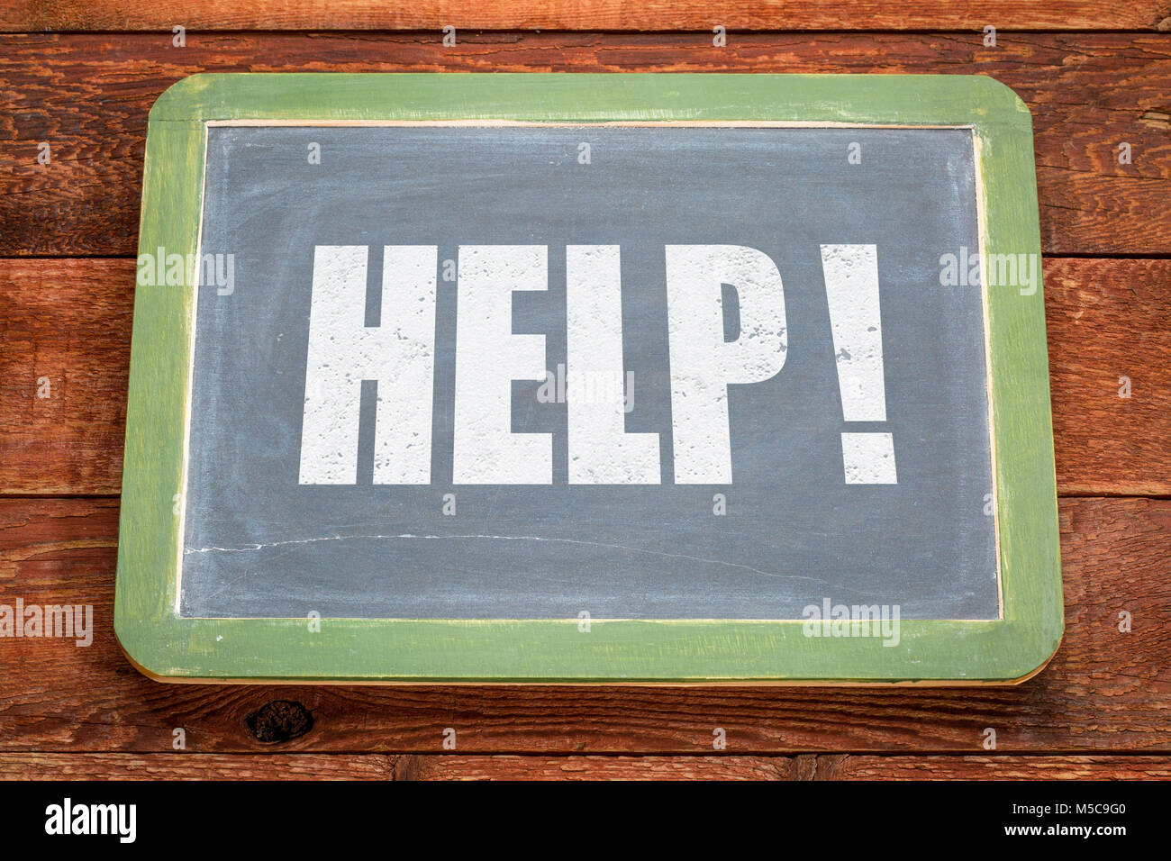 Help exclamation . White chalk text on a vintage slate blackboard ...