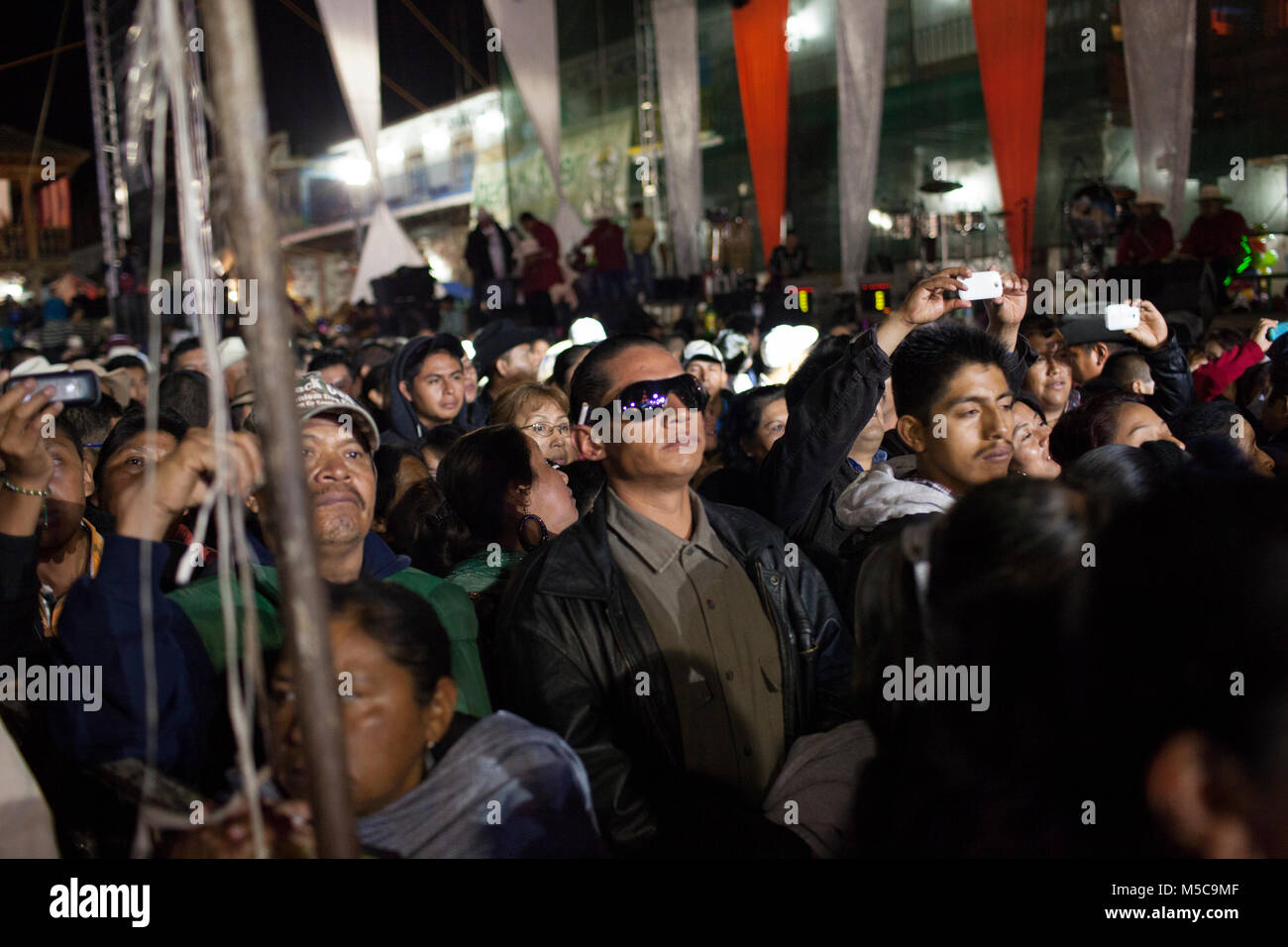 People watch a concert during the fall fiesta in Cheran, Michoacan ...
