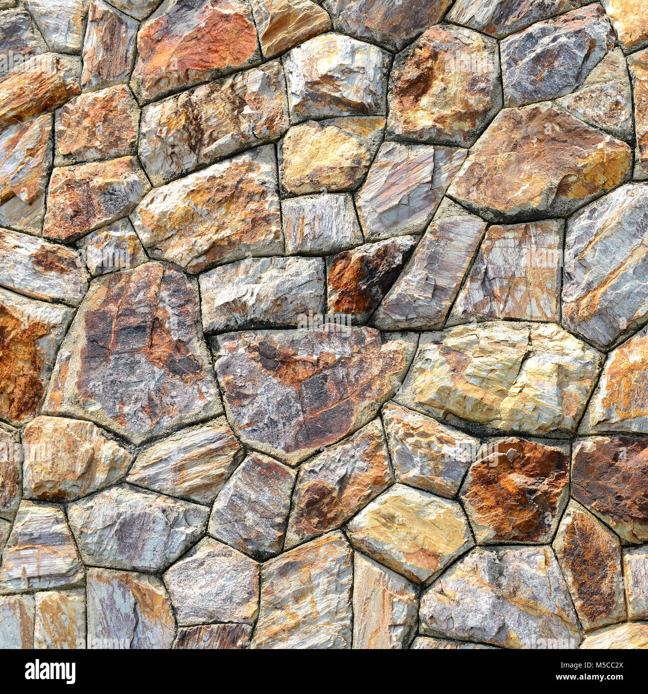 Brown stone wall texture and background Stock Photo - Alamy