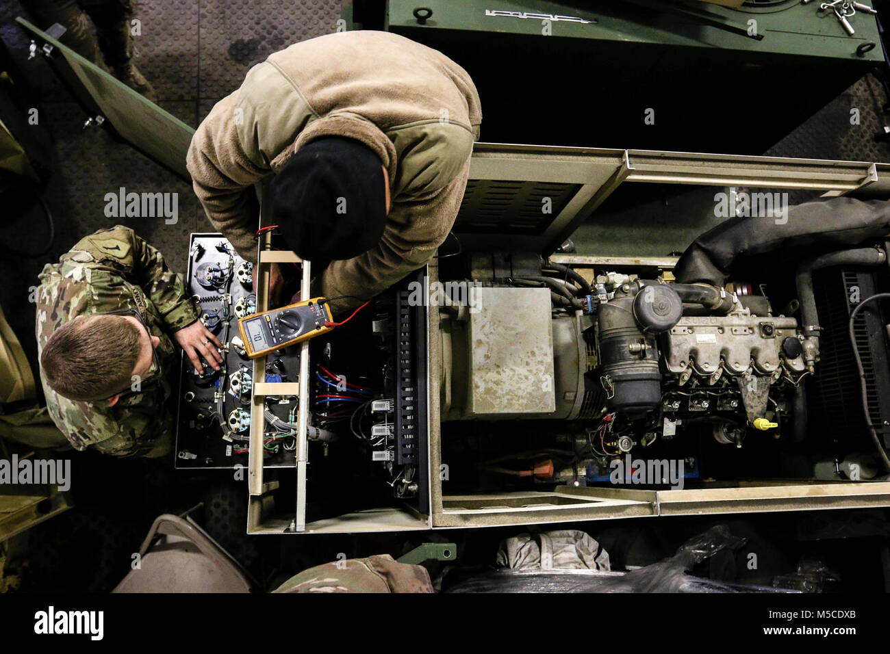 Pfc. Jesse Rhoades (left) and Spc. Jesus Fuenmayor (right), both ...