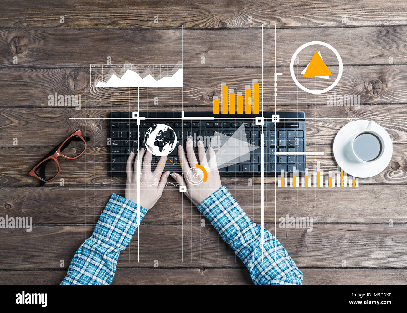 Business workplace with keyboard coffee cup and media graphs and ...